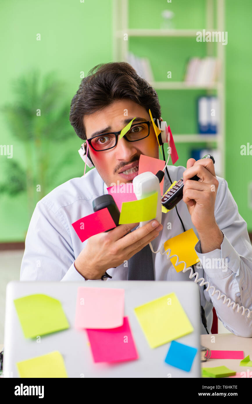 Young help desk operator working in office with many conflicting Stock ...