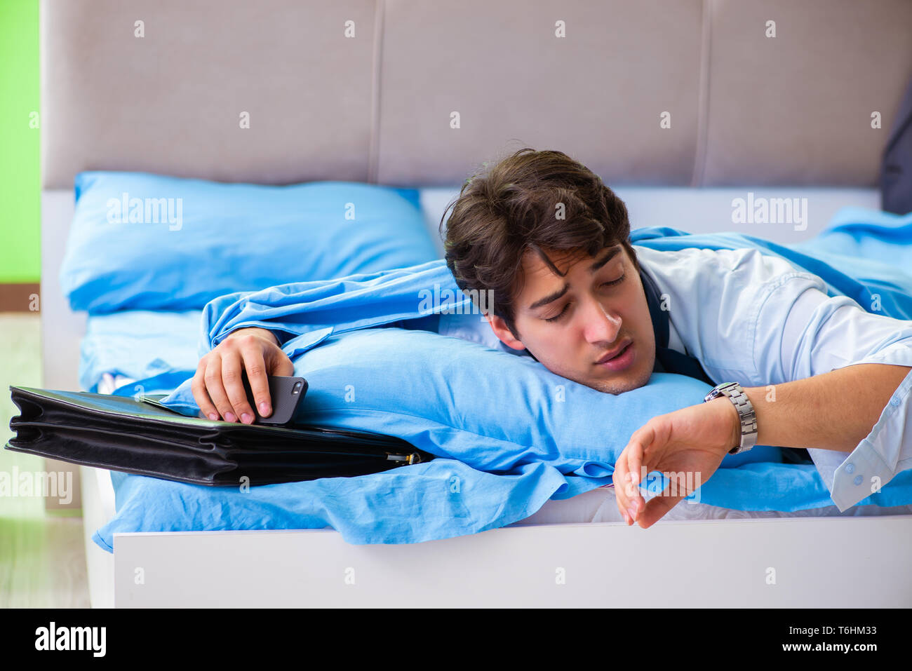Employee in the bedroom being late for his job Stock Photo - Alamy