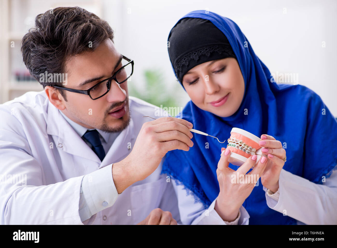 Dentist doctor and assistant working on new tooth implant Stock Photo ...