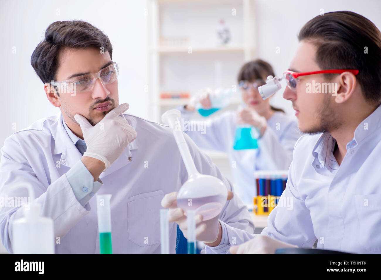 Team of chemists working in the lab Stock Photo - Alamy