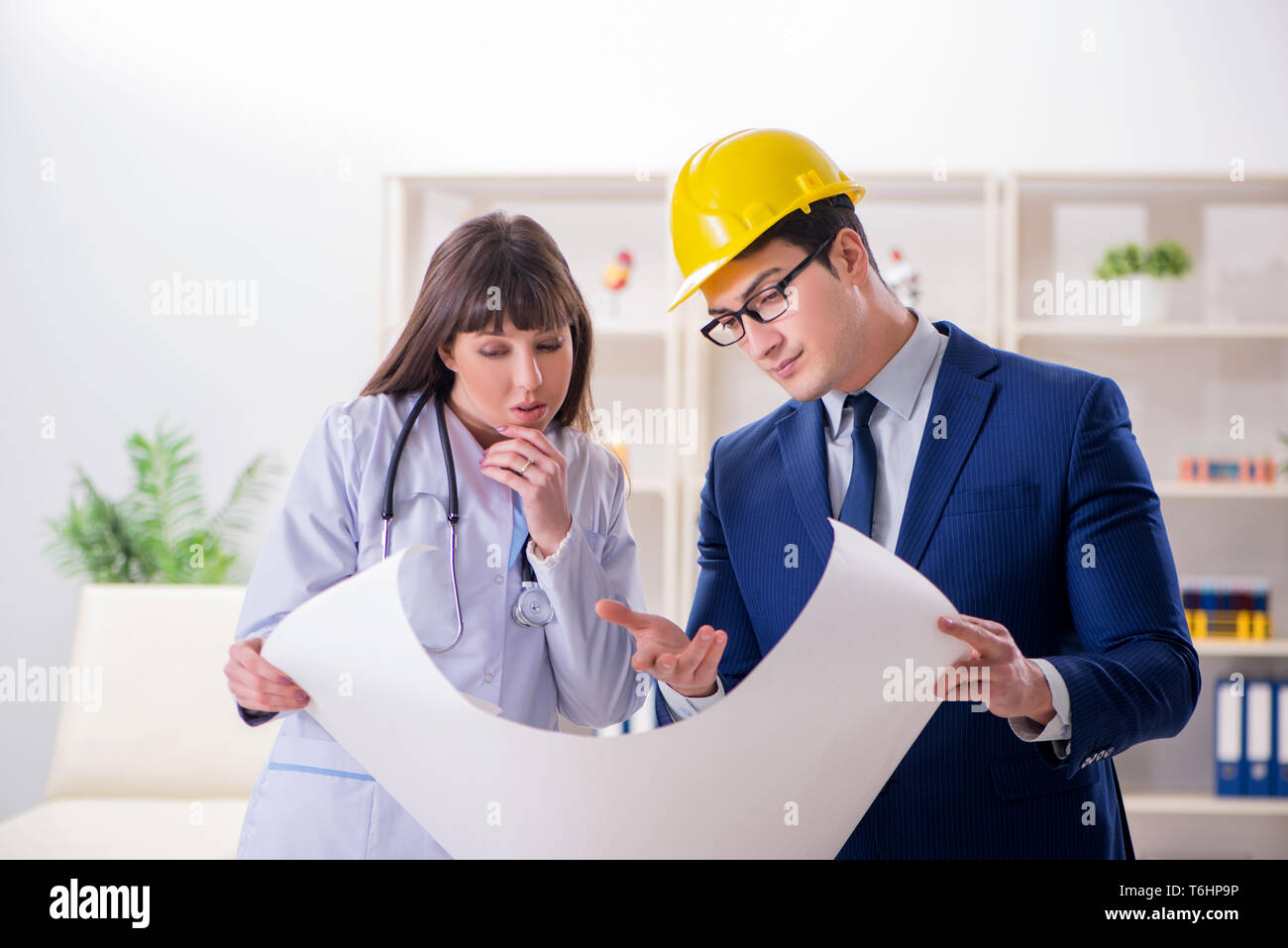 Doctor discussing new hospital plan with architect Stock Photo - Alamy