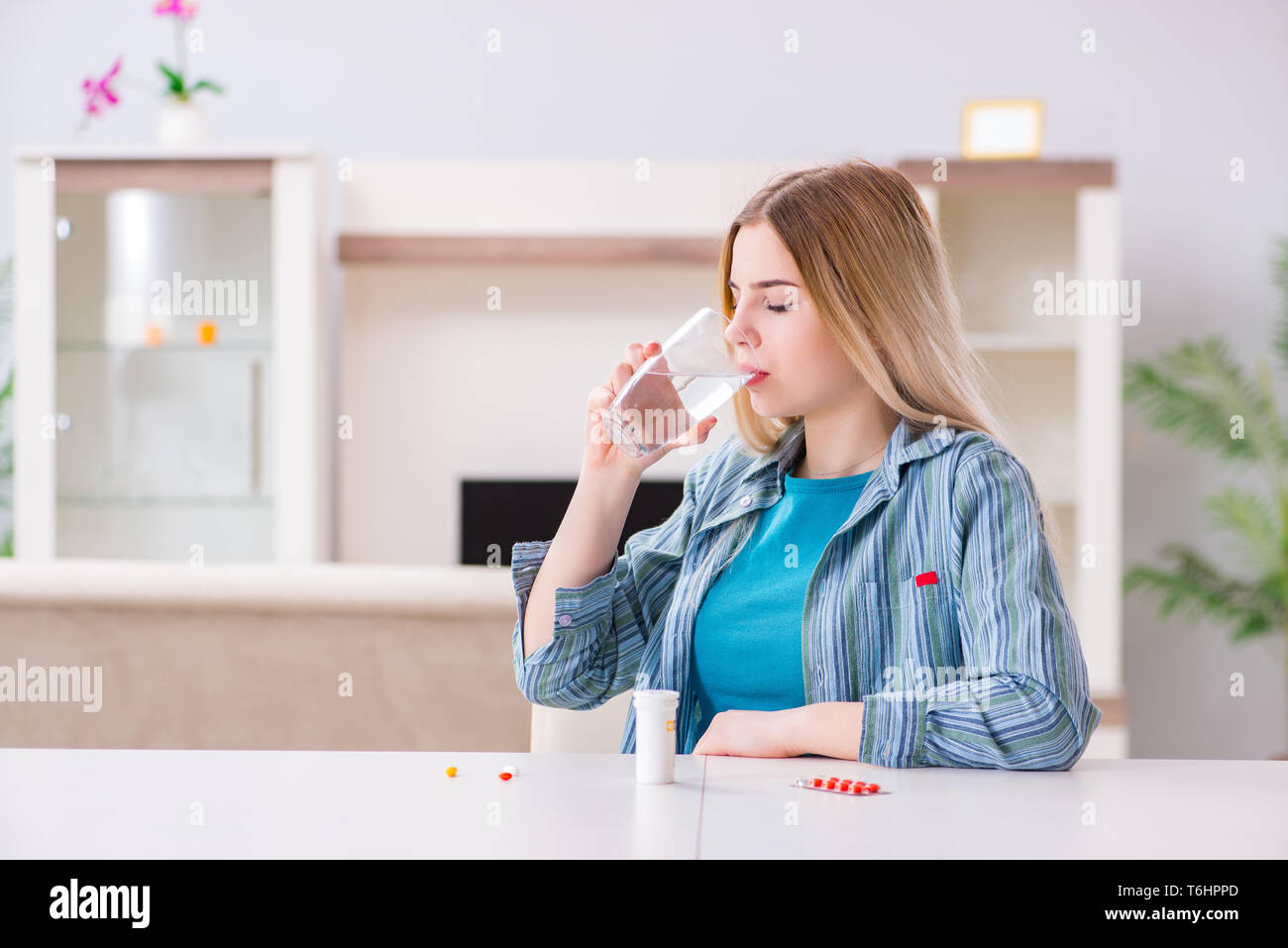 Woman taking pills drinking glass hi-res stock photography and images ...