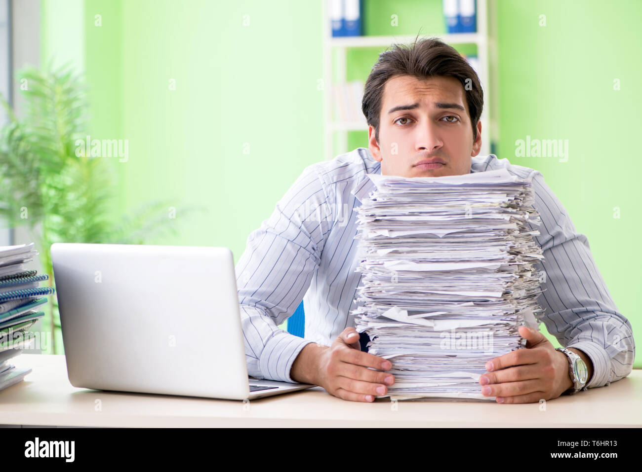 Businessman having problems with paperwork and workload Stock Photo - Alamy