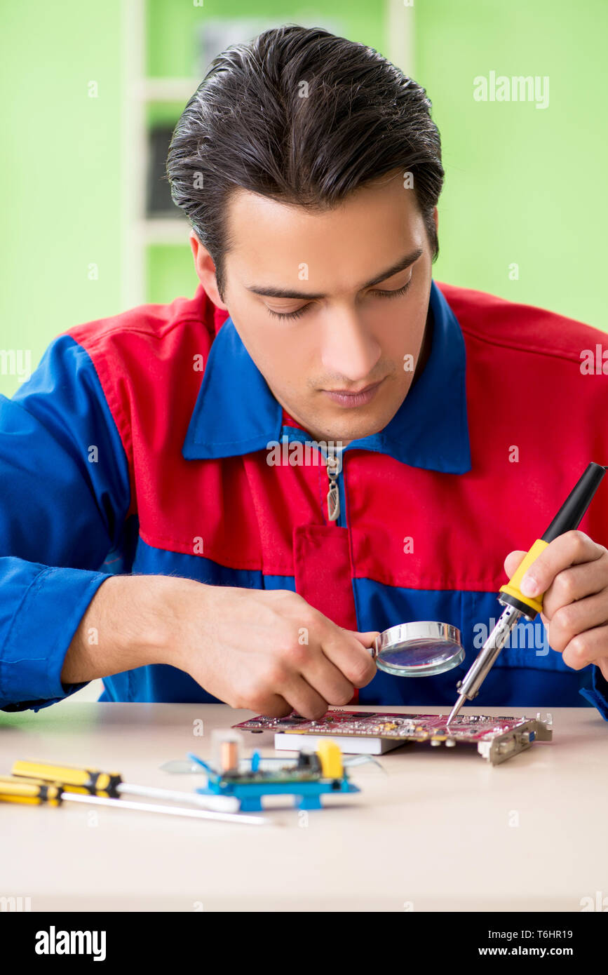 Computer engineer repairing broken desktop Stock Photo - Alamy