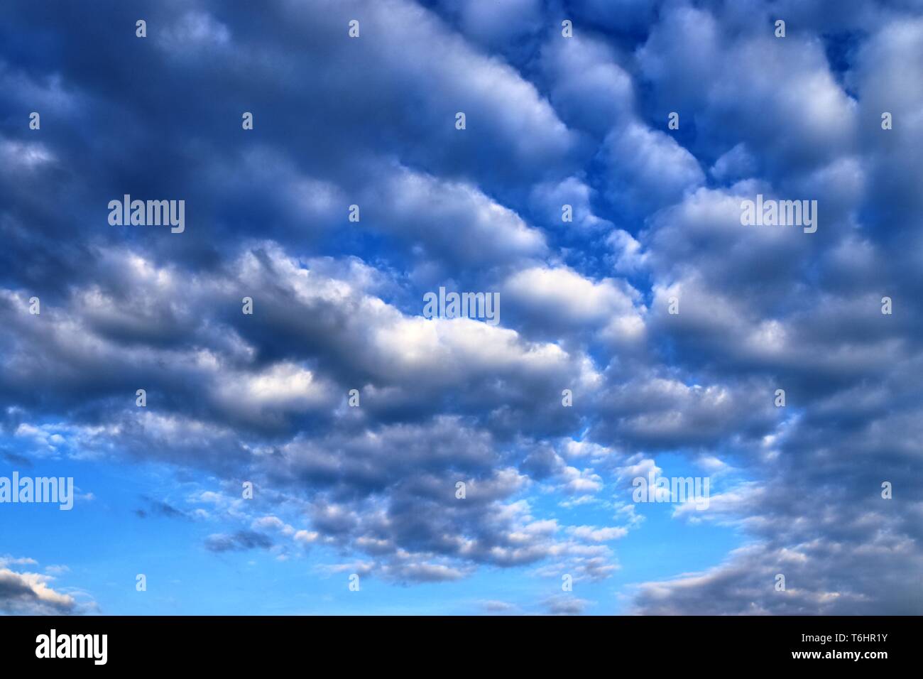 Beautiful mixed cloud formation with white and grey cumulus clouds in ...