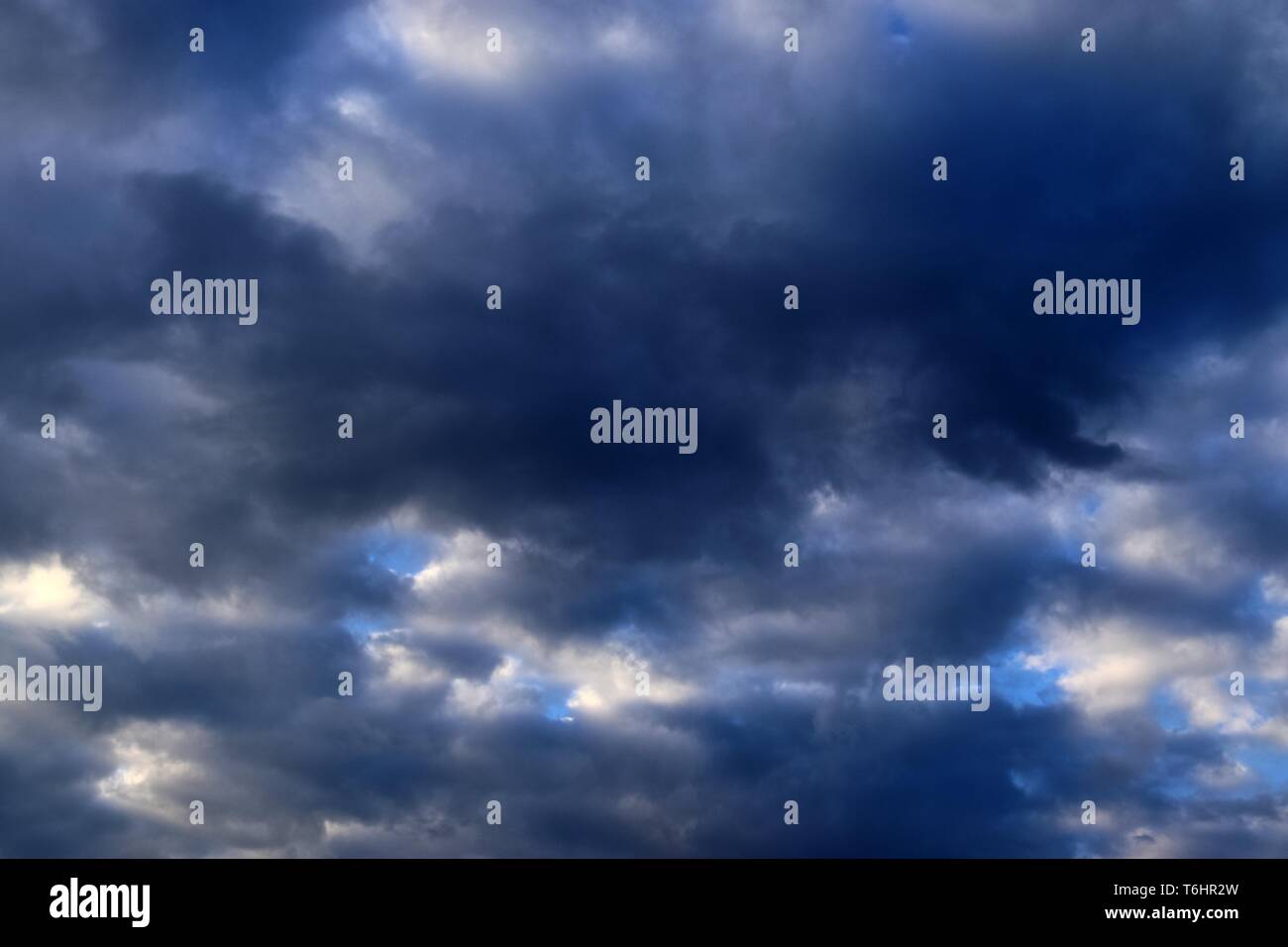 Beautiful mixed cloud formation with white and grey cumulus clouds in ...