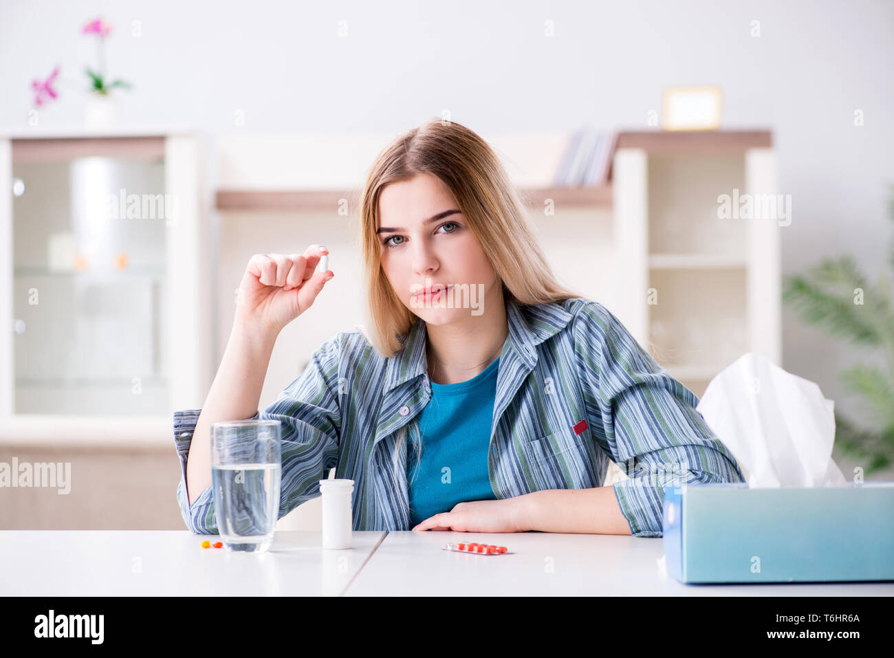 Woman taking pills to cope with pain Stock Photo - Alamy