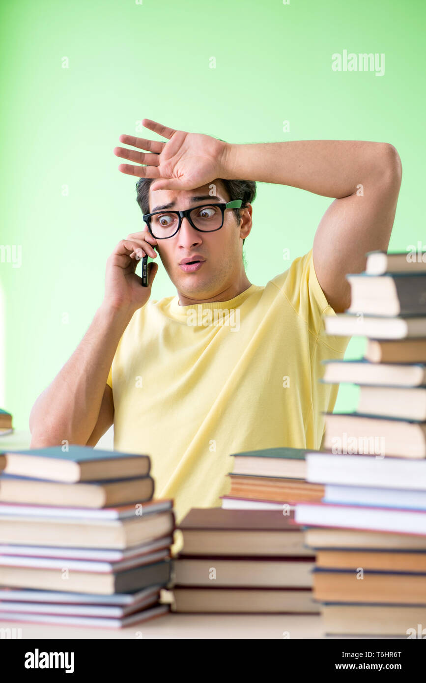 Student with too many books to read before exam Stock Photo - Alamy