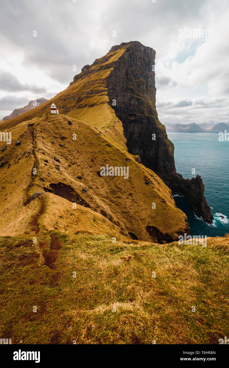 Hike towards Kallur lighthouse on Kalsoy island with high cliffs ...