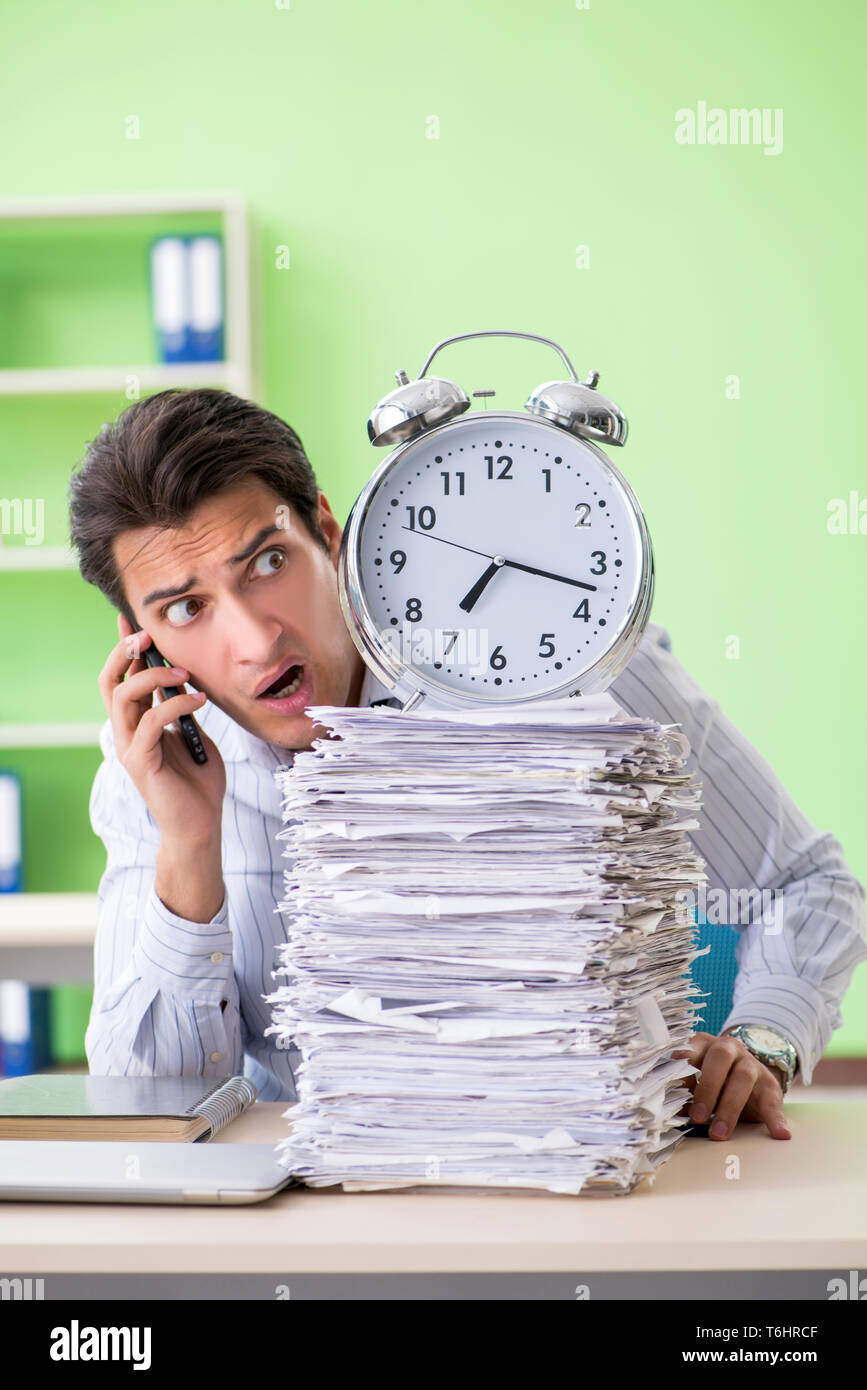Businessman having problems with paperwork and workload Stock Photo - Alamy