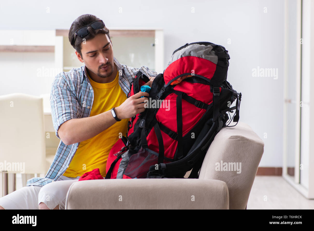 Backpacker packing for his trip Stock Photo - Alamy