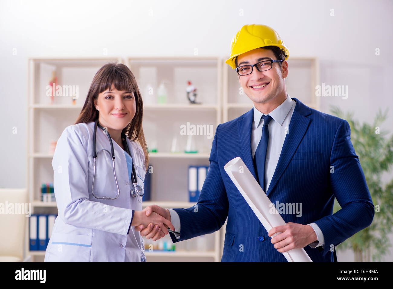 Doctor discussing new hospital plan with architect Stock Photo - Alamy