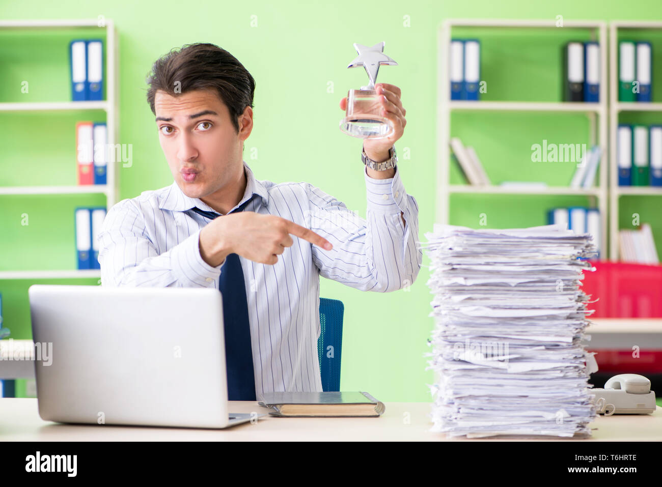 Businessman having problems with paperwork and workload Stock Photo - Alamy