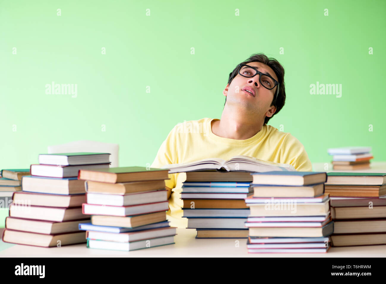 Student with too many books to read before exam Stock Photo - Alamy