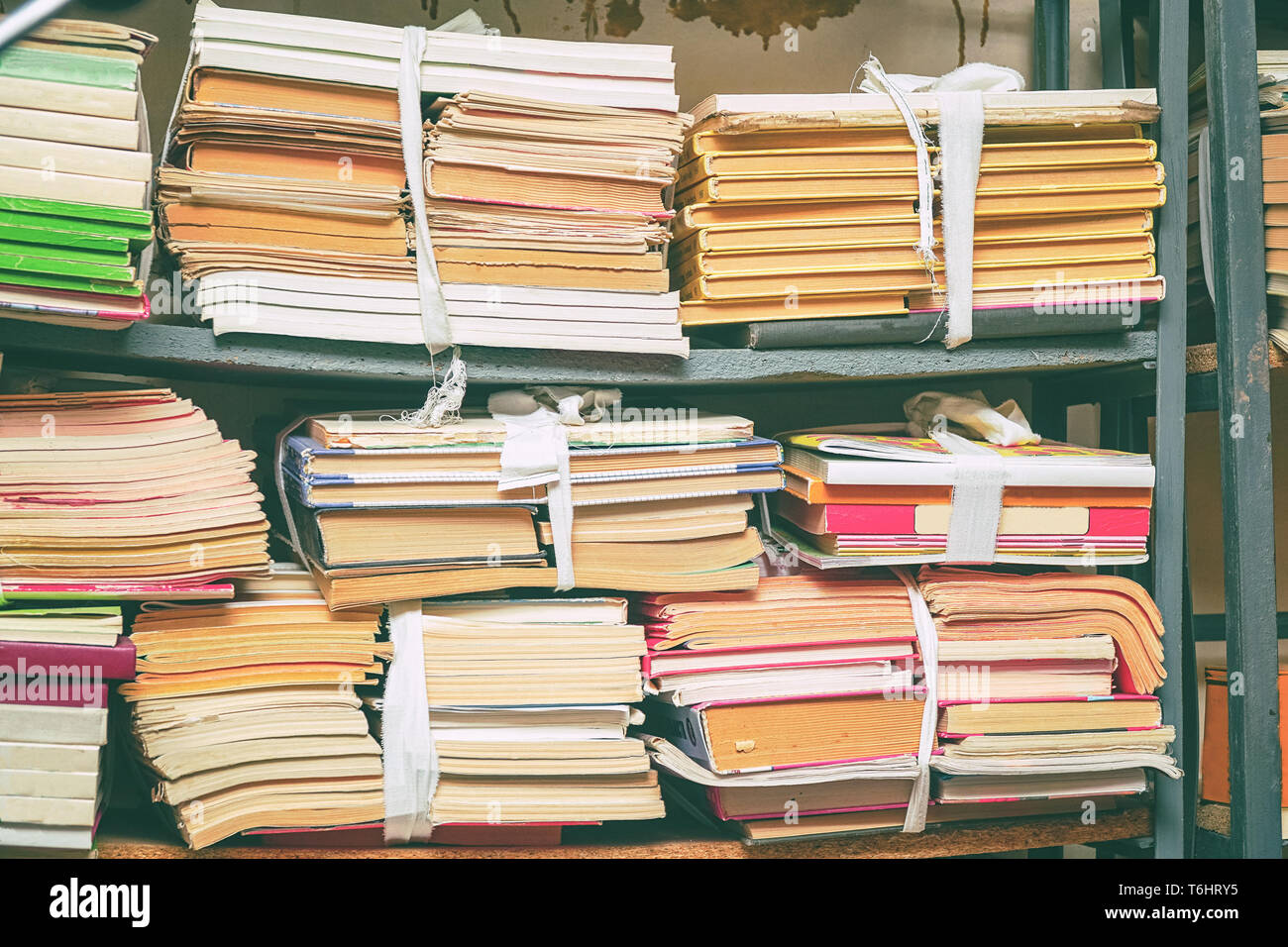 Old books in stacks on the shelf Stock Photo - Alamy
