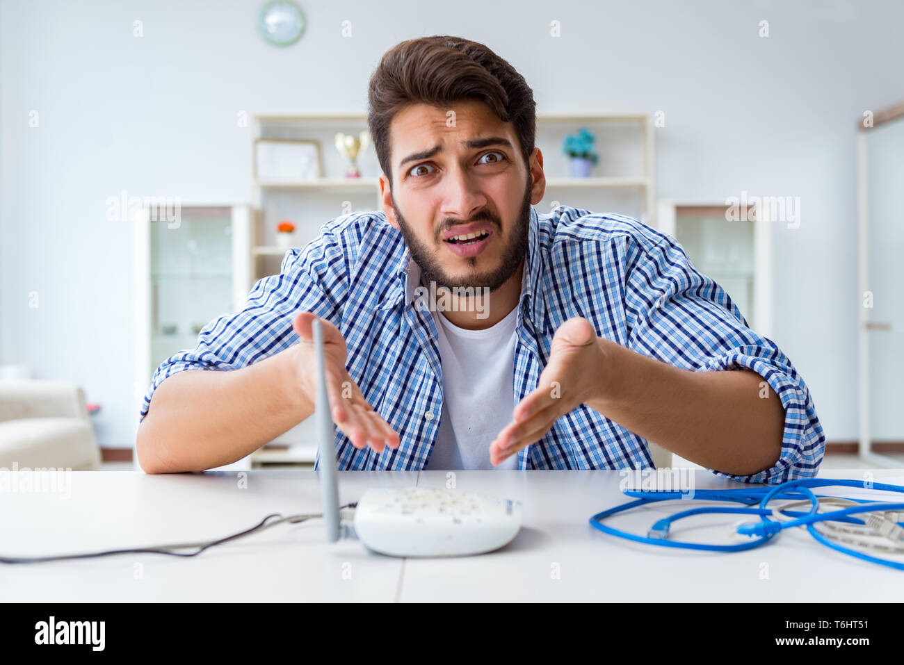 Frustrated young man due to weak internet reception Stock Photo - Alamy