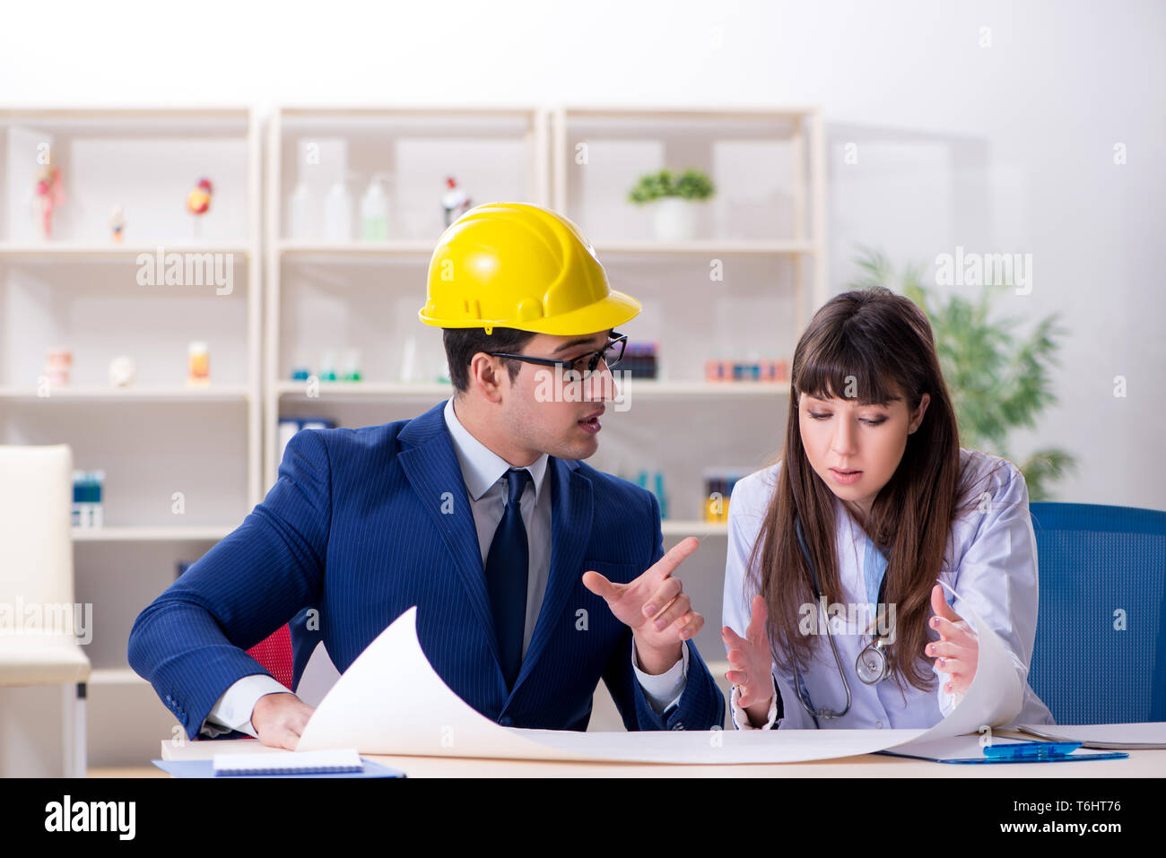 Doctor discussing new hospital plan with architect Stock Photo - Alamy