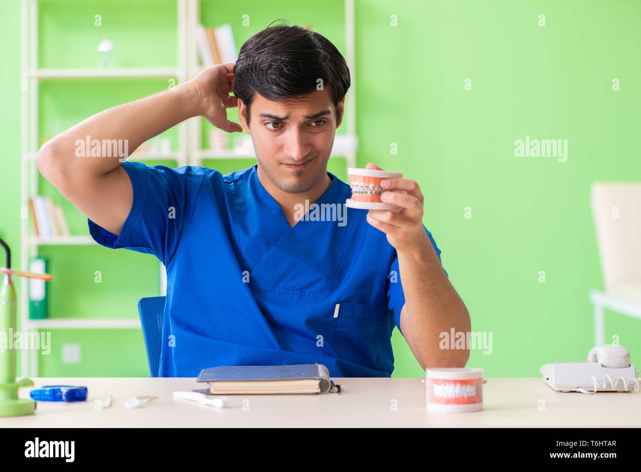 Man dentist working on new teeth implant Stock Photo - Alamy