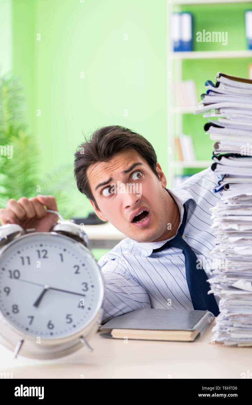 Businessman having problems with paperwork and workload Stock Photo - Alamy