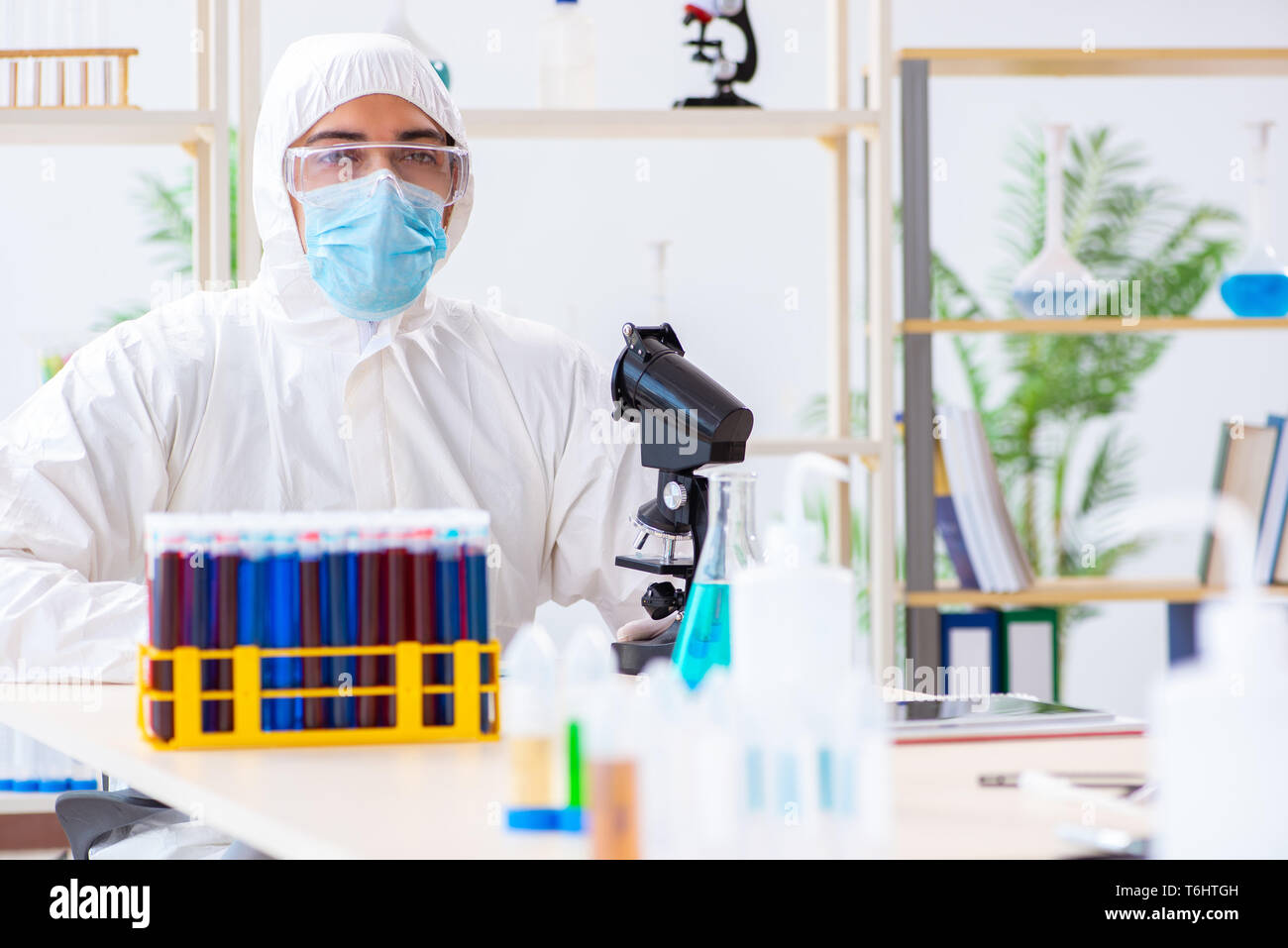 Young chemist student working in lab on chemicals Stock Photo - Alamy