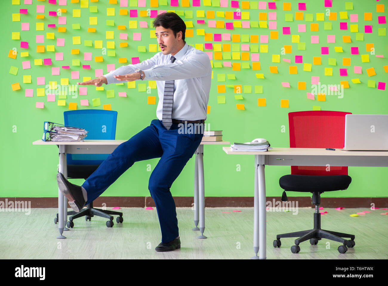 Man in the office with many conflicting priorities doing exercis Stock ...