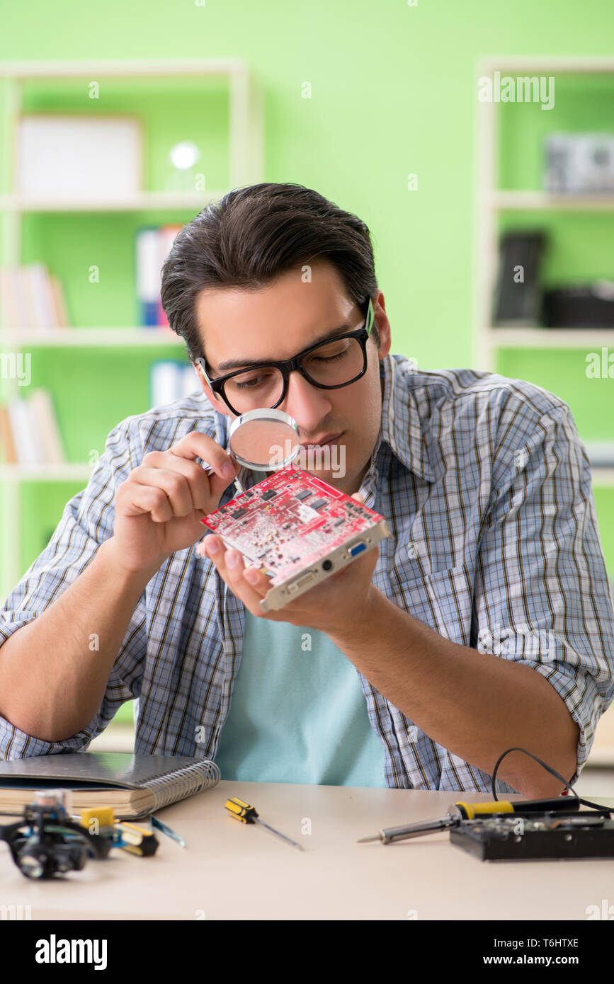 Computer engineer repairing broken desktop Stock Photo - Alamy