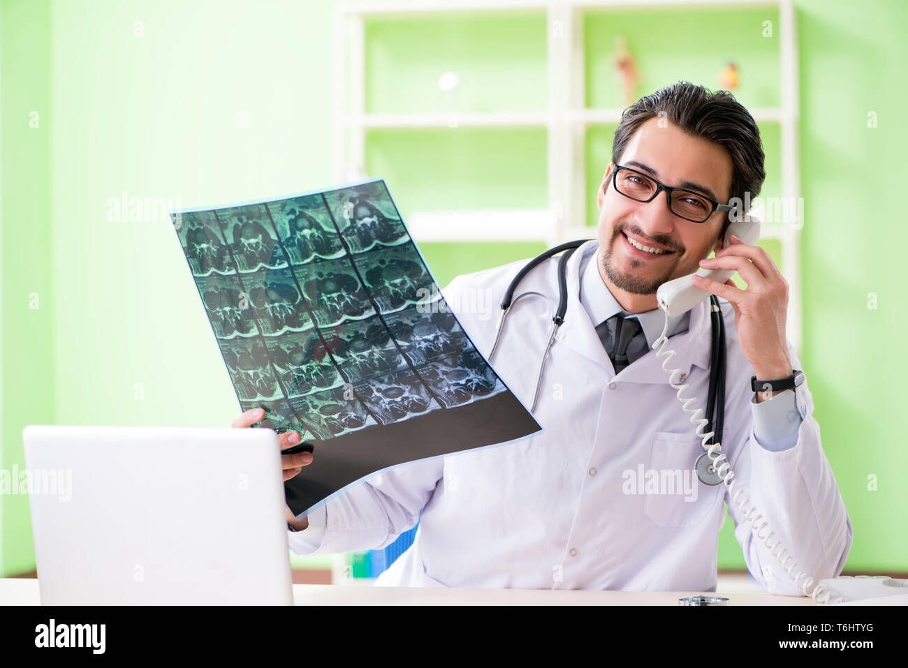 Doctor radiologist looking at x-ray scan in hospital Stock Photo - Alamy