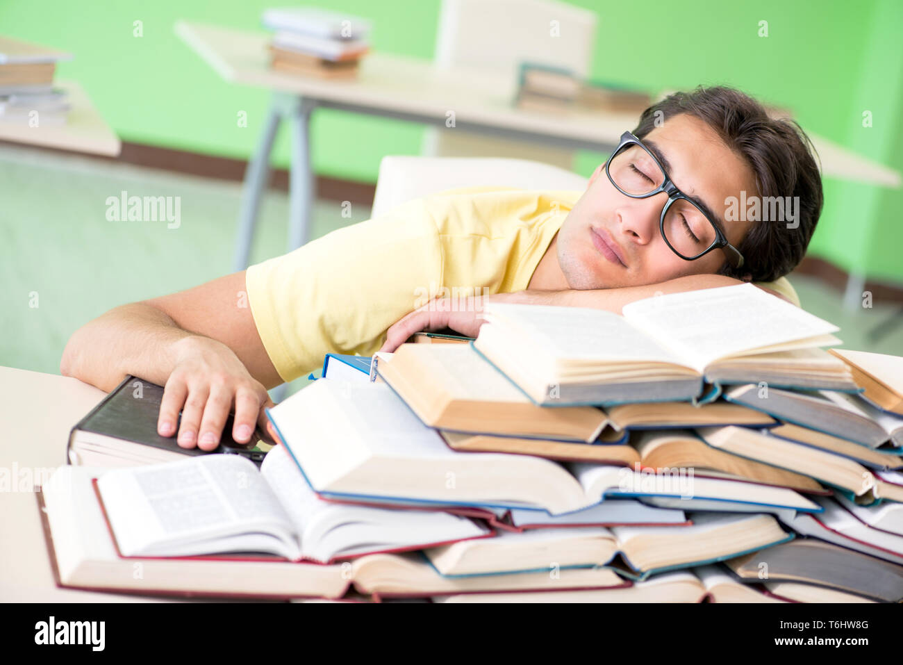Student with too many books to read before exam Stock Photo - Alamy