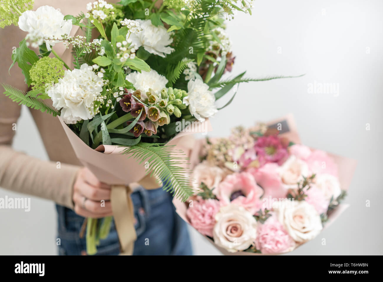 Two Beautiful bouquets of mixed flowers in womans hands. the work of ...