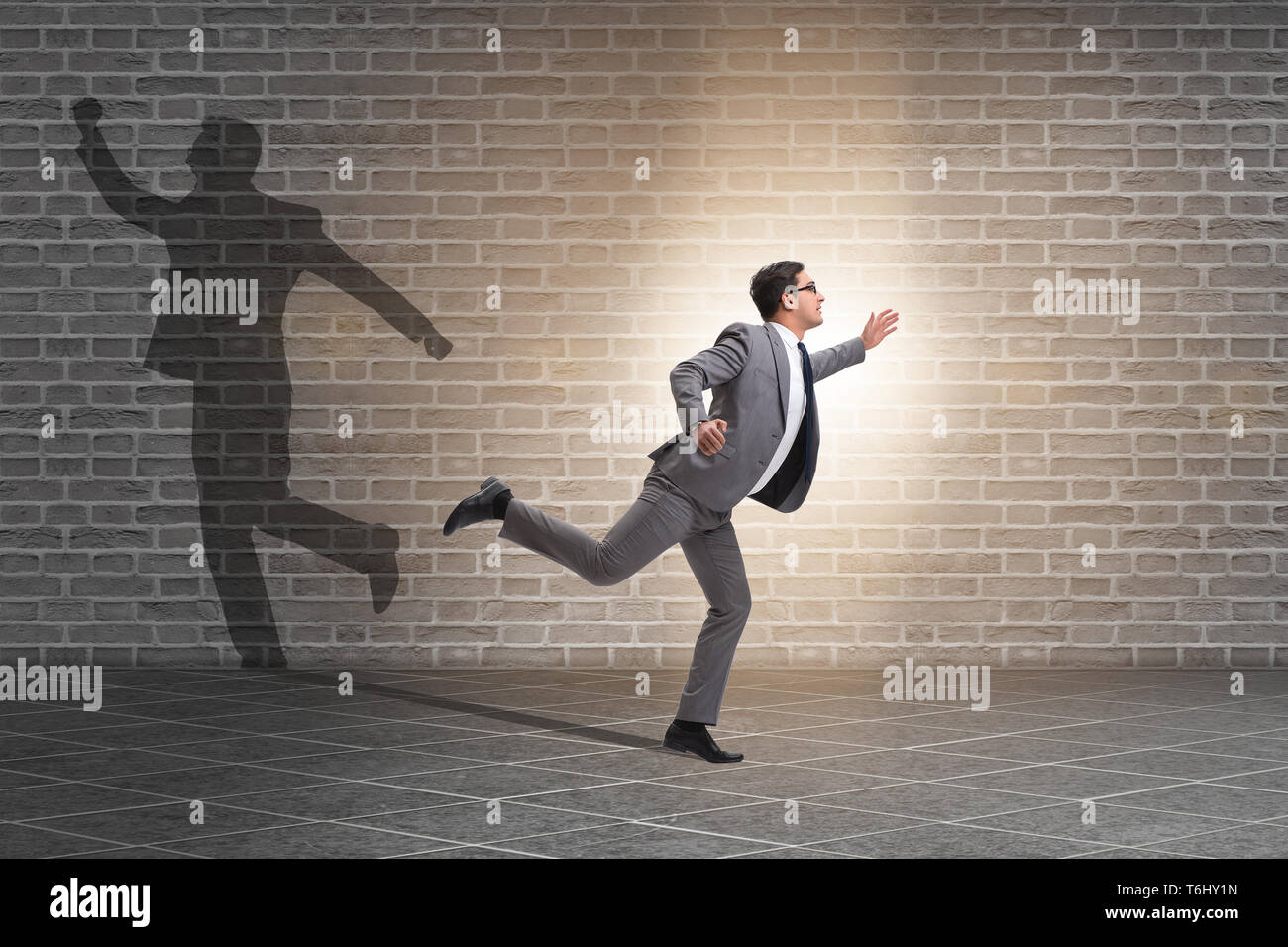 Businessman and his shadow in business concept Stock Photo - Alamy