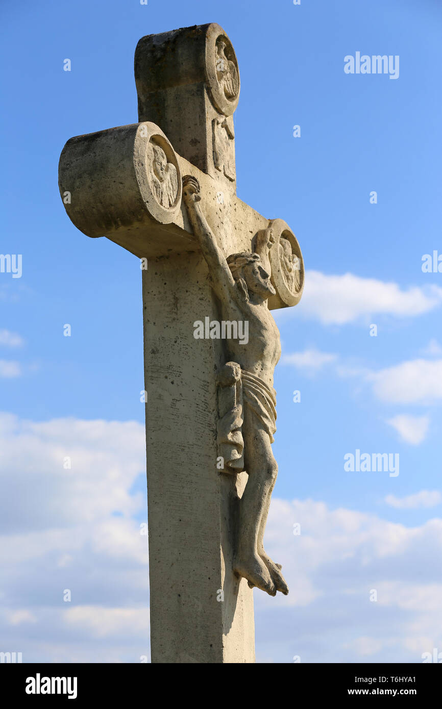 Jesus Christ on white stone cross sculpture. White stone cross against ...