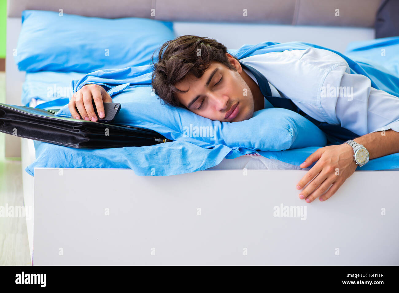 Employee in the bedroom being late for his job Stock Photo - Alamy