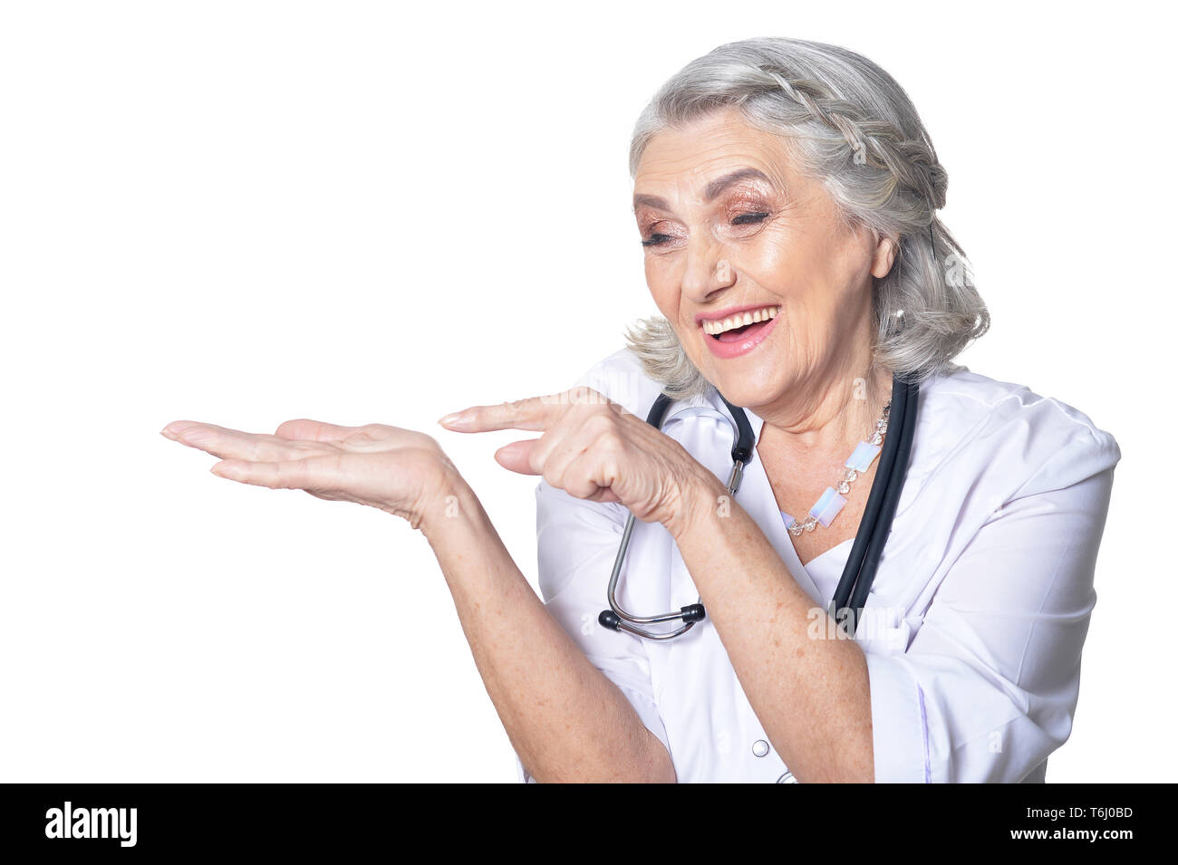 Senior female doctor showing something isolated on white background ...