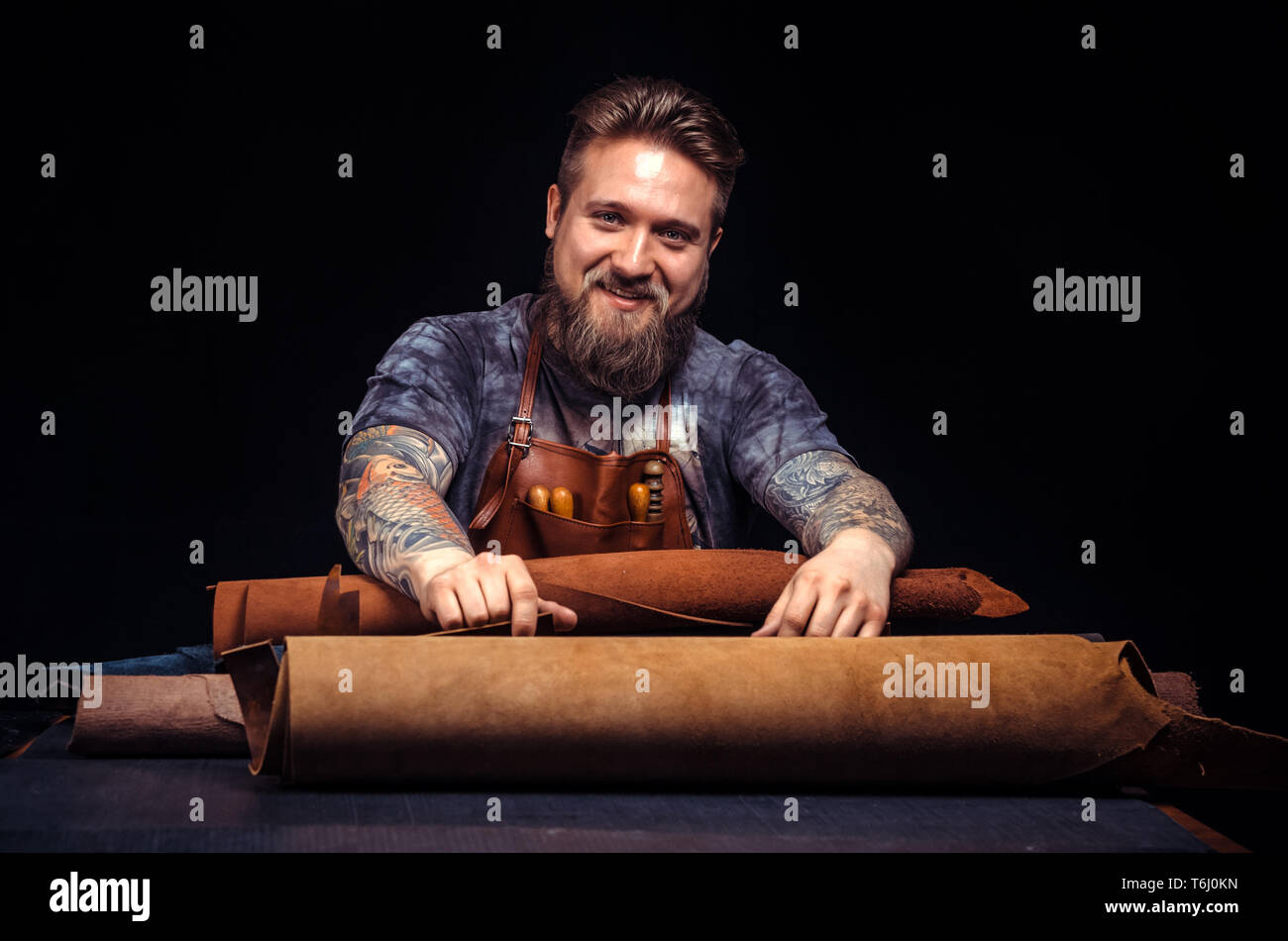 Worker of leather creating new leatherwork at his leather studio Stock ...