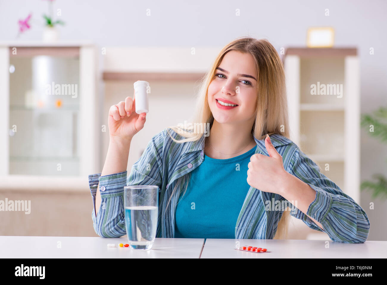 Young happy woman taking pills hi-res stock photography and images - Alamy