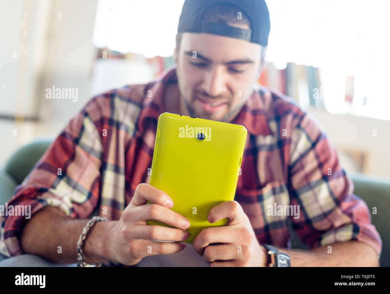 Person relaxing using a tablet at home Stock Photo - Alamy