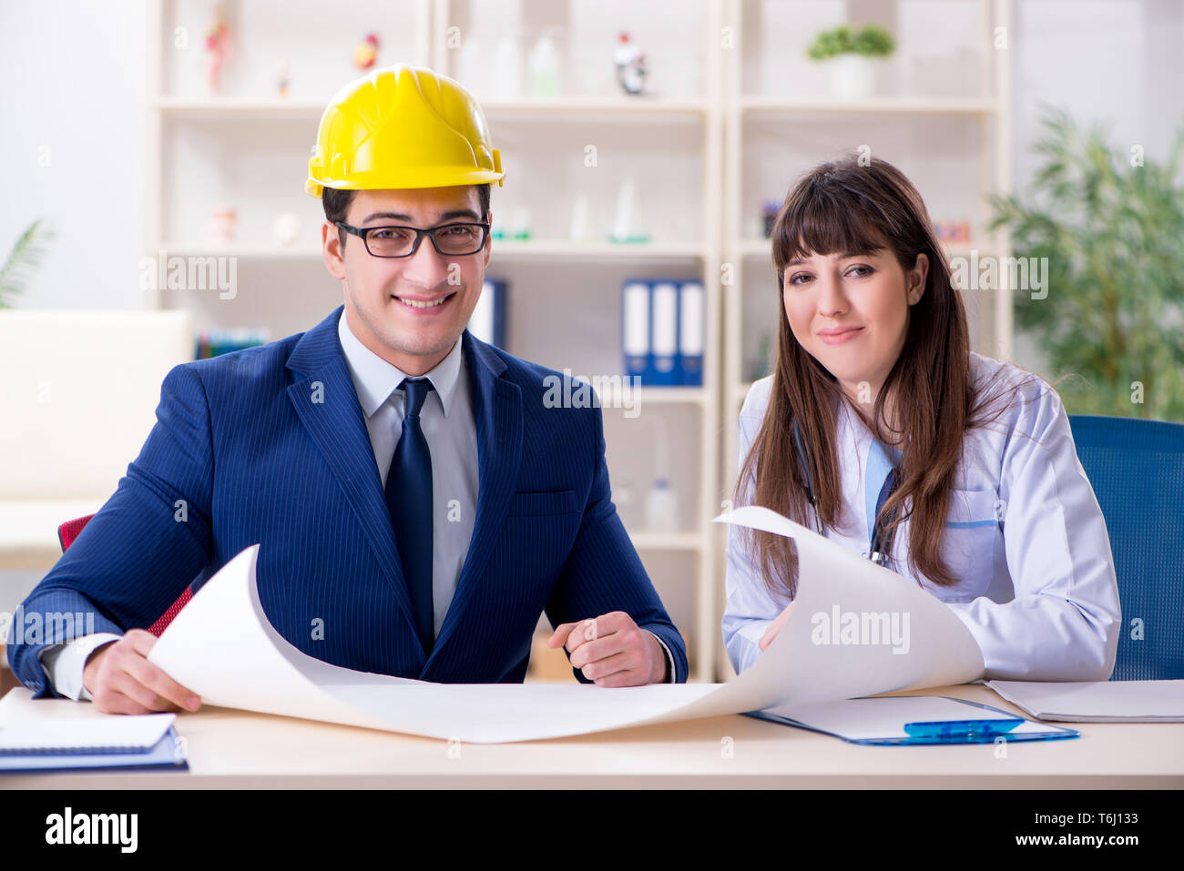 Doctor discussing new hospital plan with architect Stock Photo - Alamy