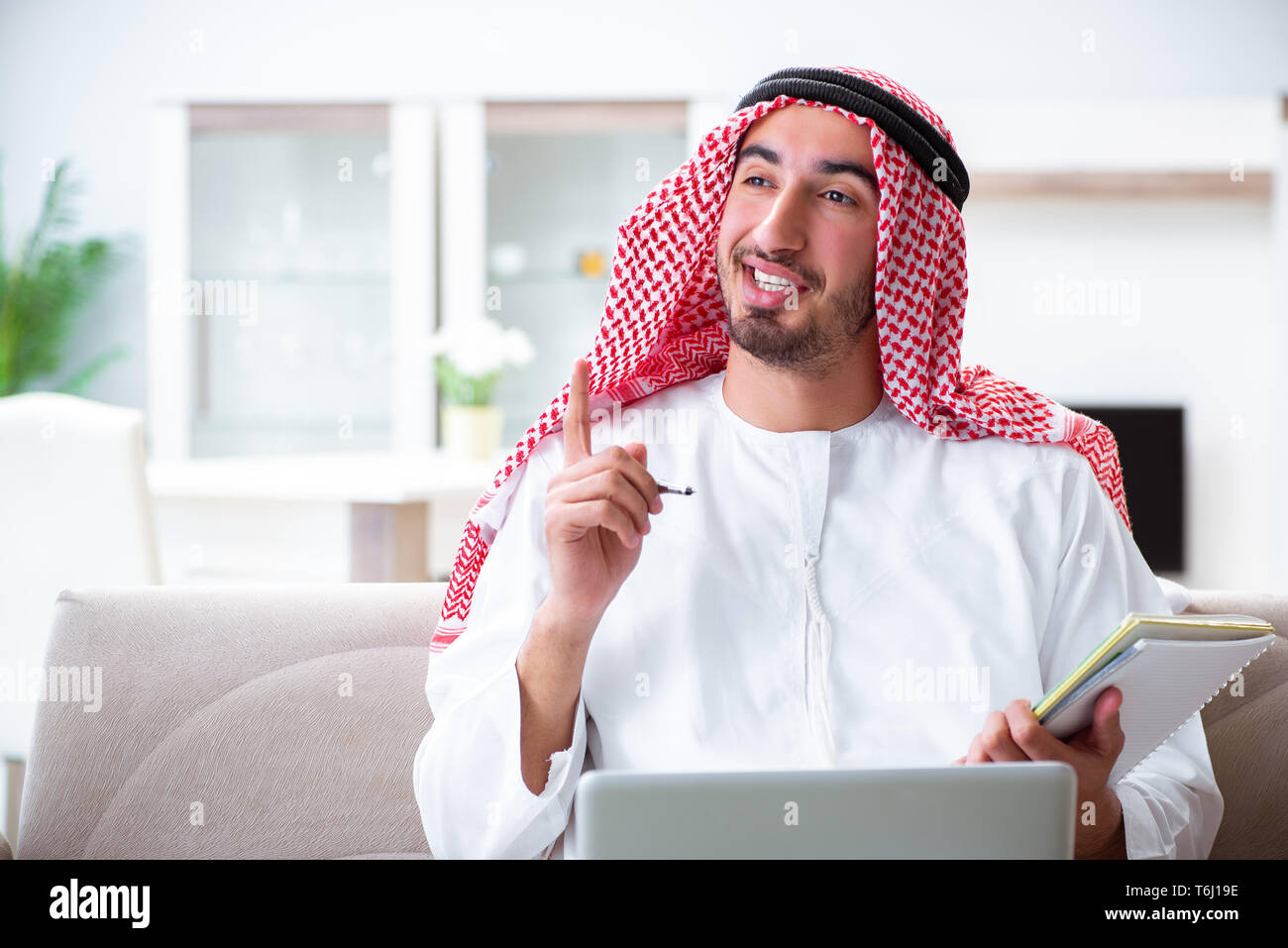 Arab man working at home on his work Stock Photo - Alamy