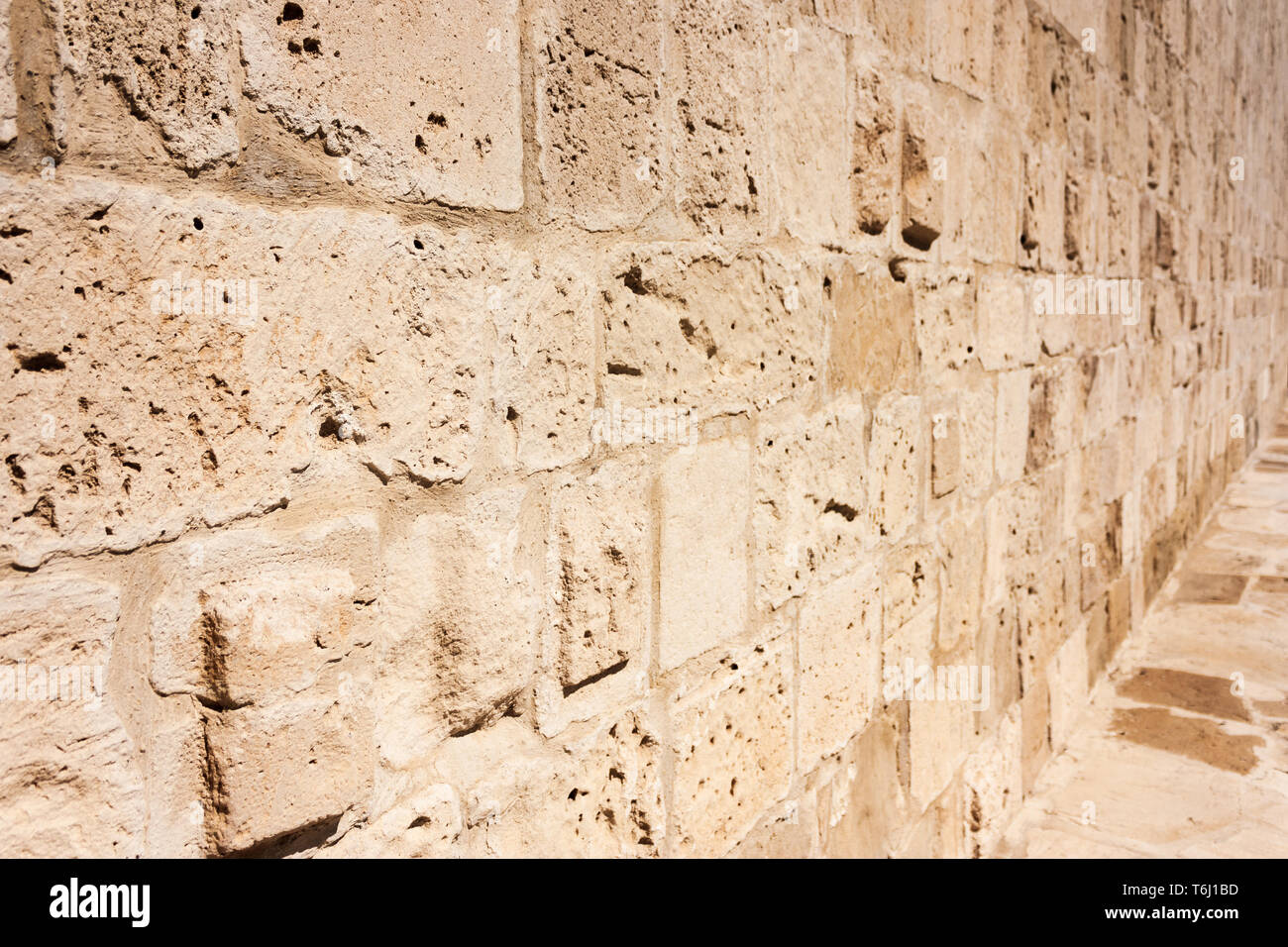 Old, brown, sandy, wall of a stone house in the open air. Seamless ...