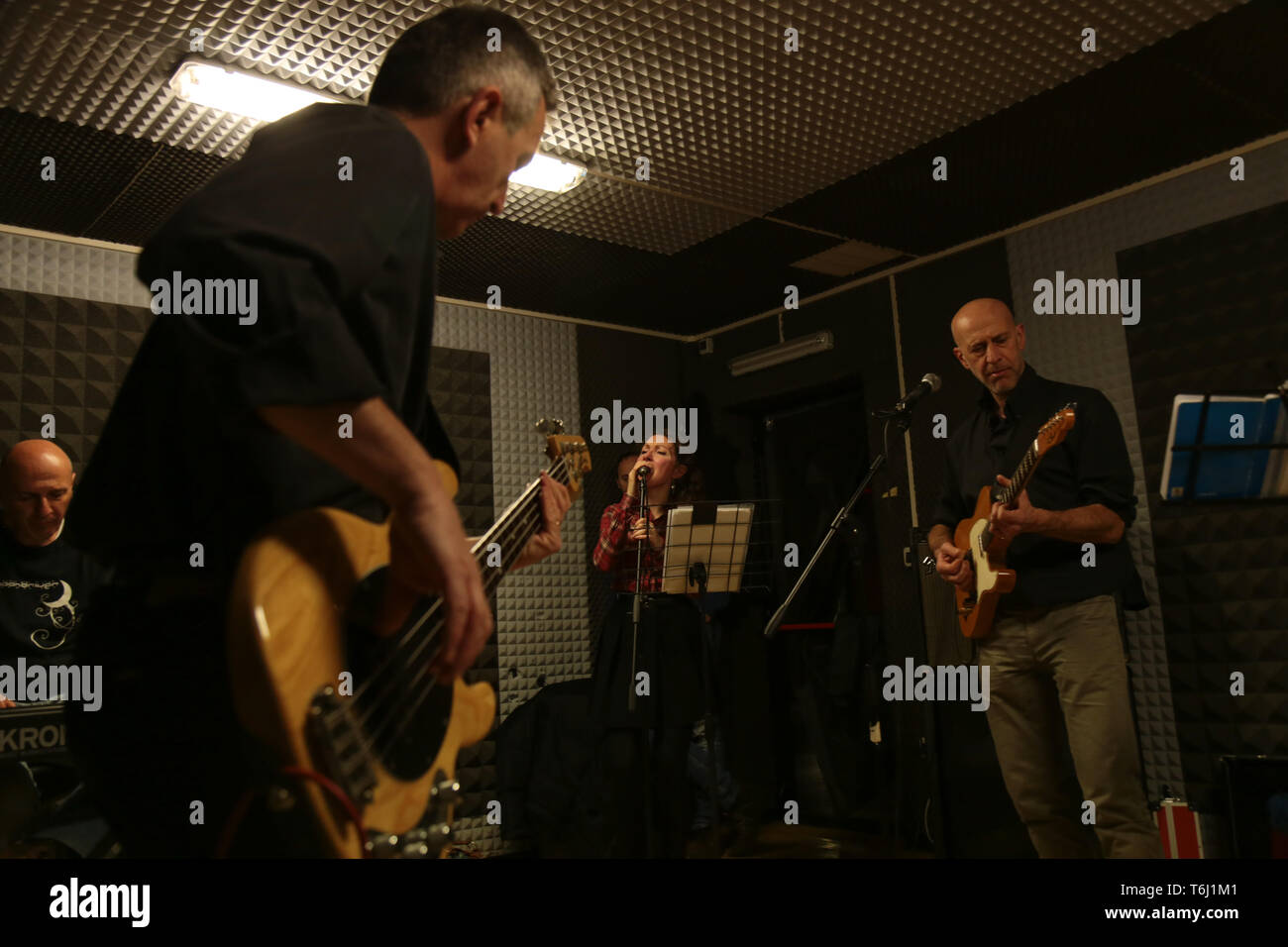 Music band playing in a rehearsal room. Low Key Stock Photo - Alamy