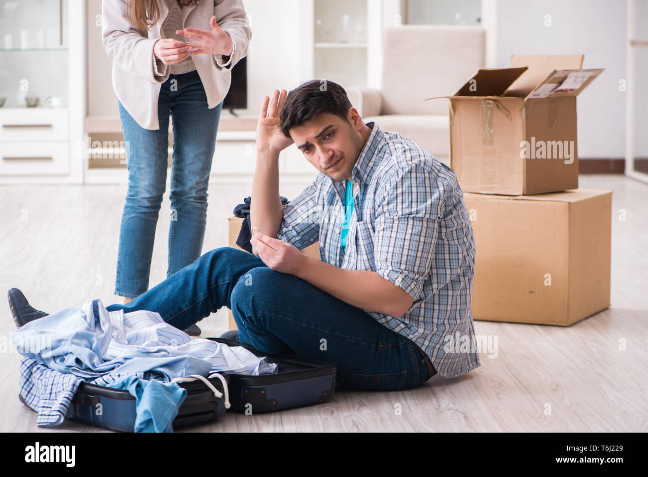 Woman evicting man from house during family conflict Stock Photo - Alamy