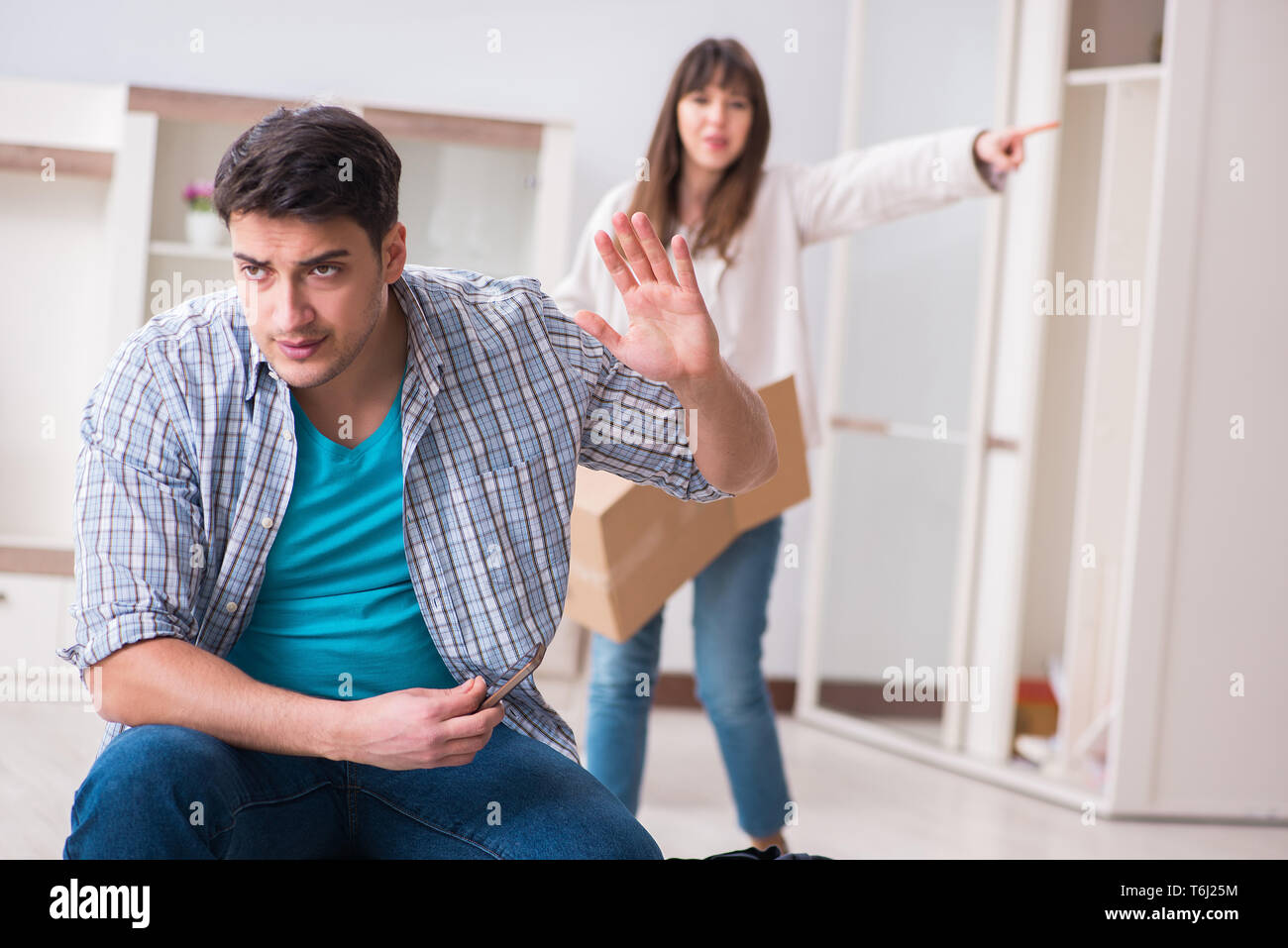 Woman evicting man from house during family conflict Stock Photo - Alamy
