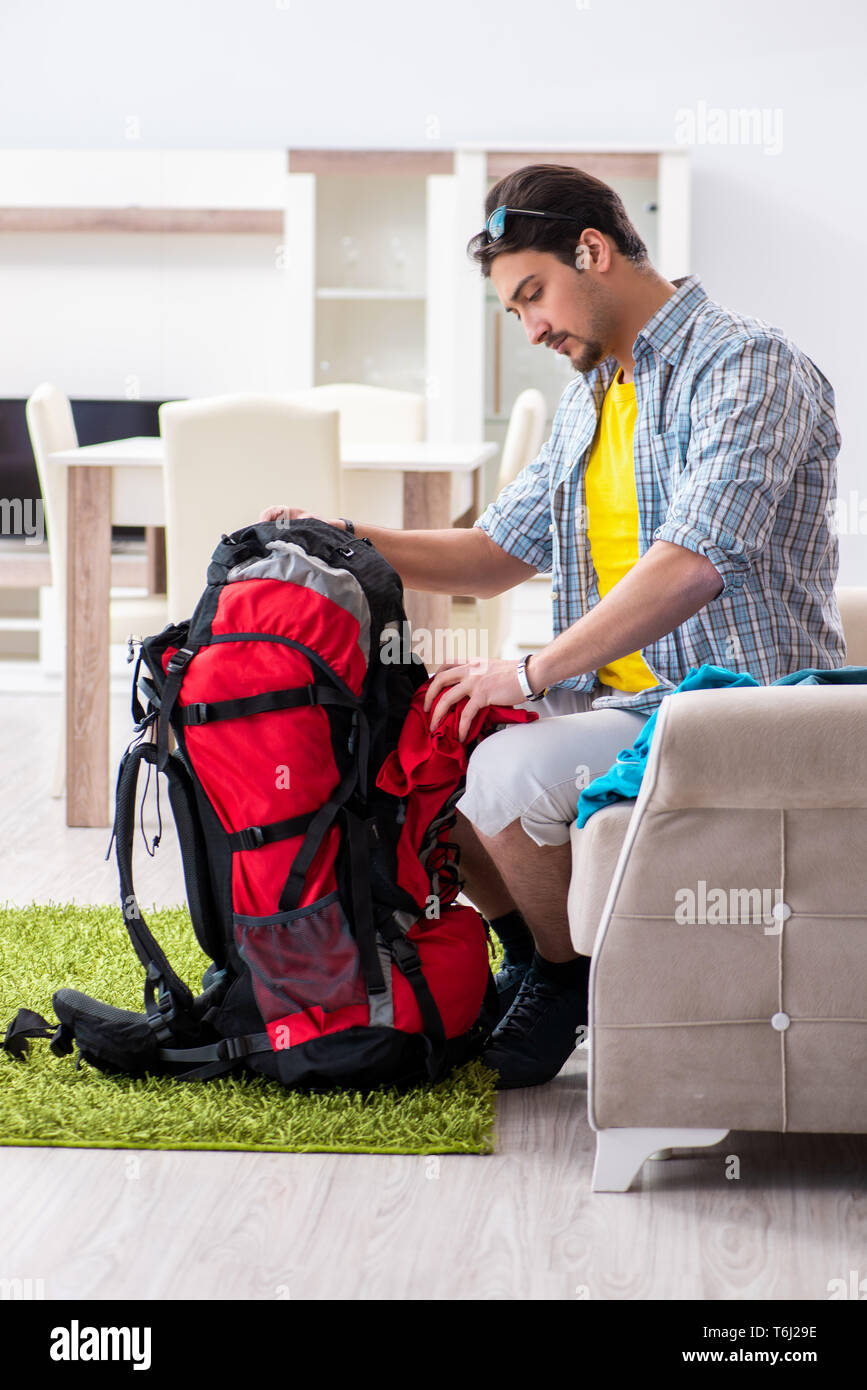 Backpacker packing for his trip Stock Photo - Alamy