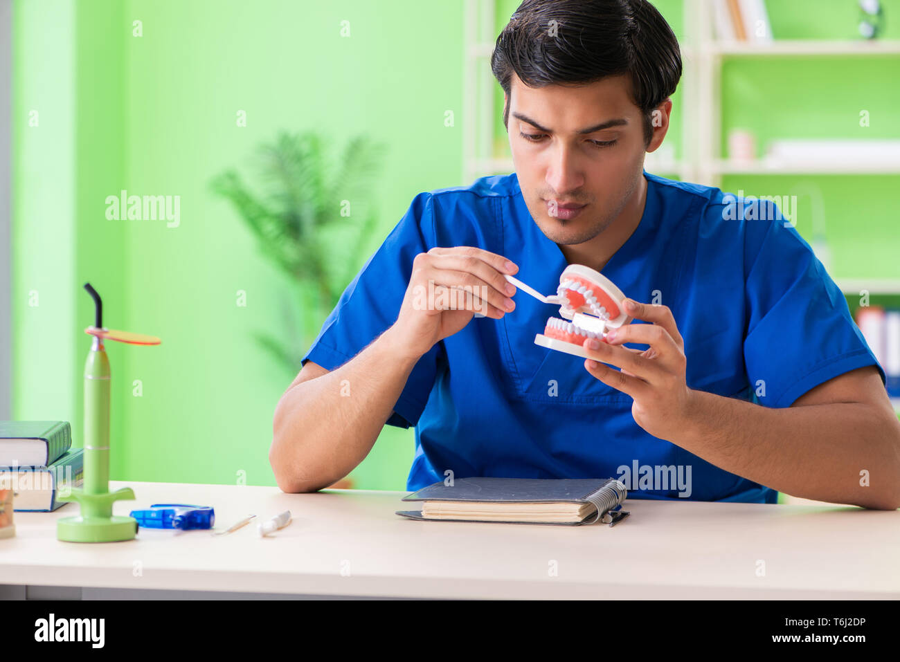 Man dentist working on new teeth implant Stock Photo - Alamy