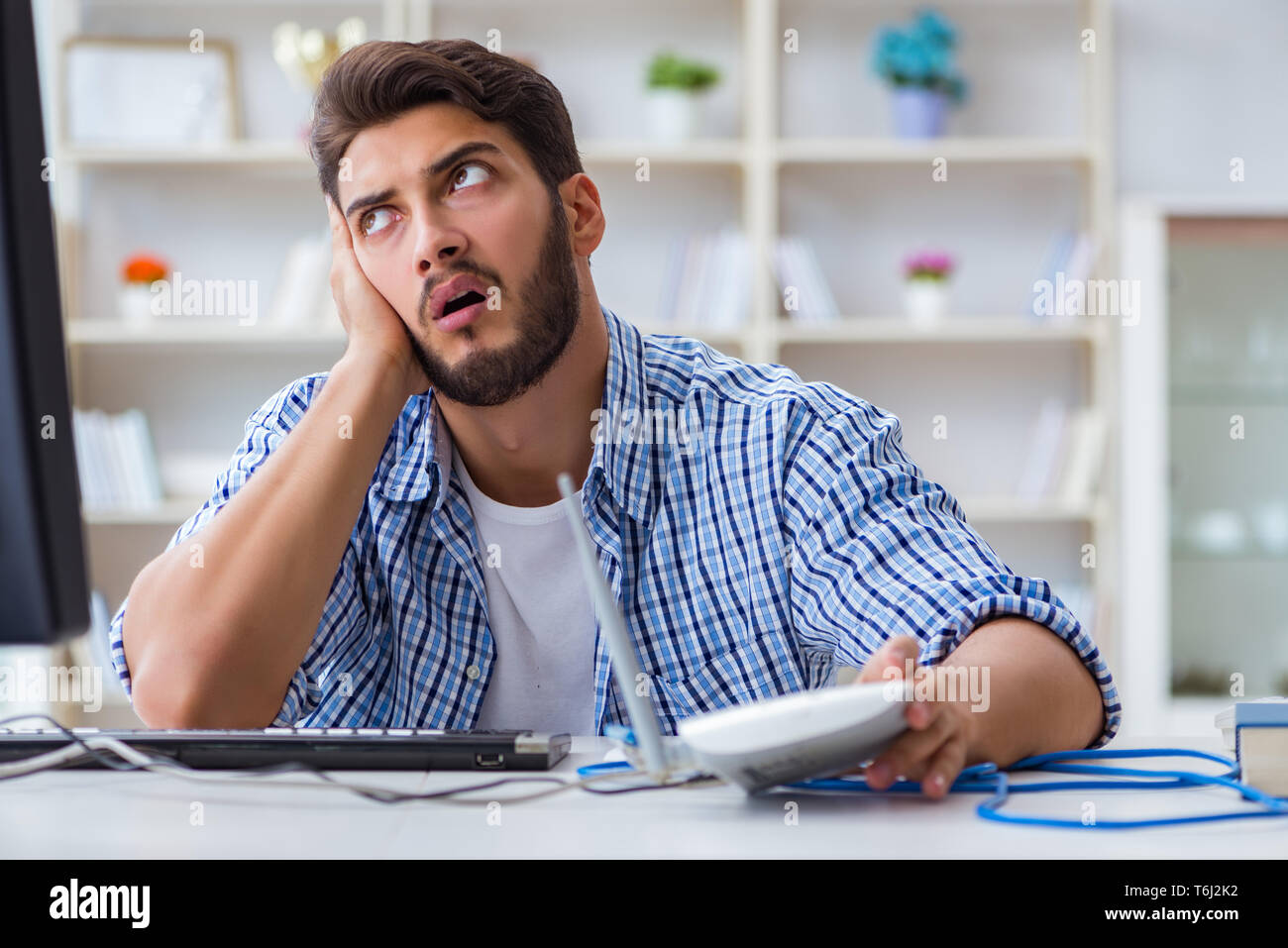 Frustrated young man due to weak internet reception Stock Photo - Alamy