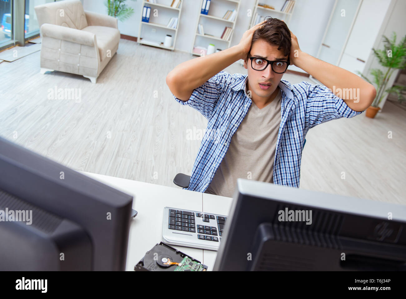 Young trader monitoring markets on screens Stock Photo - Alamy