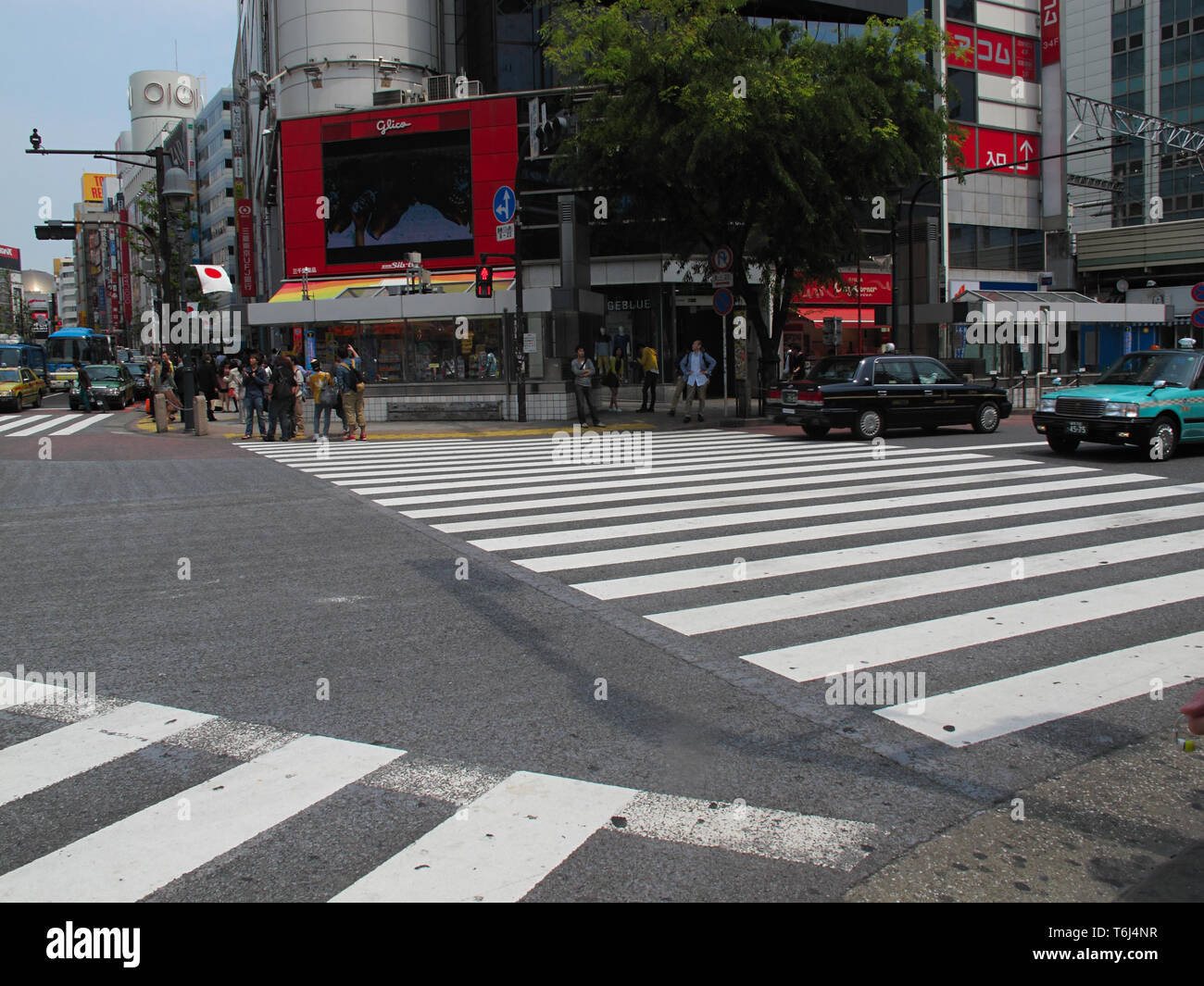 Pedestrians cross Shibuya Crossing, one of the busiest crosswalks in ...