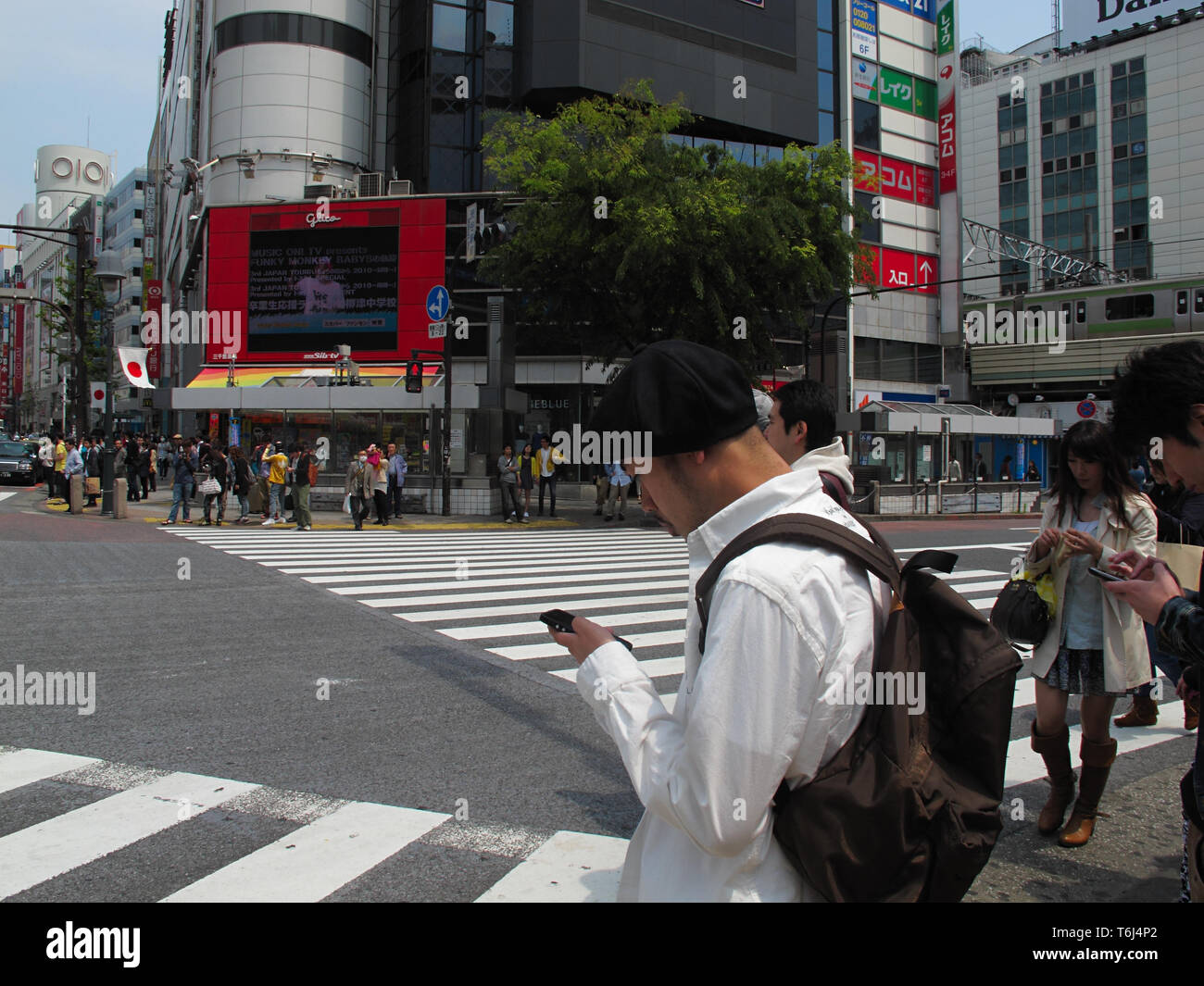 Pedestrians cross Shibuya Crossing, one of the busiest crosswalks in ...