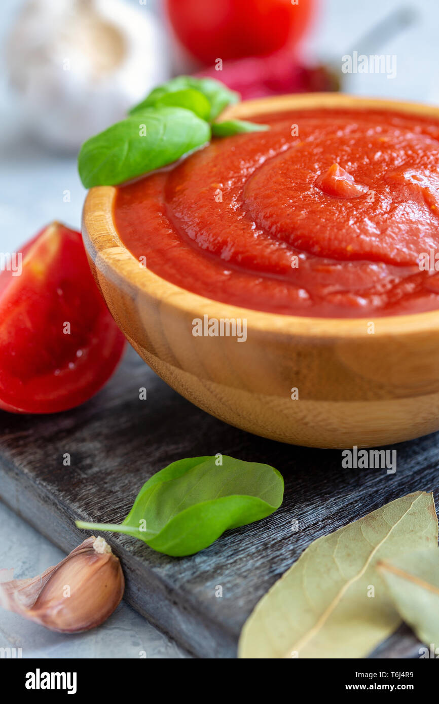 Spicy tomato sauce in a wooden bowl Stock Photo - Alamy