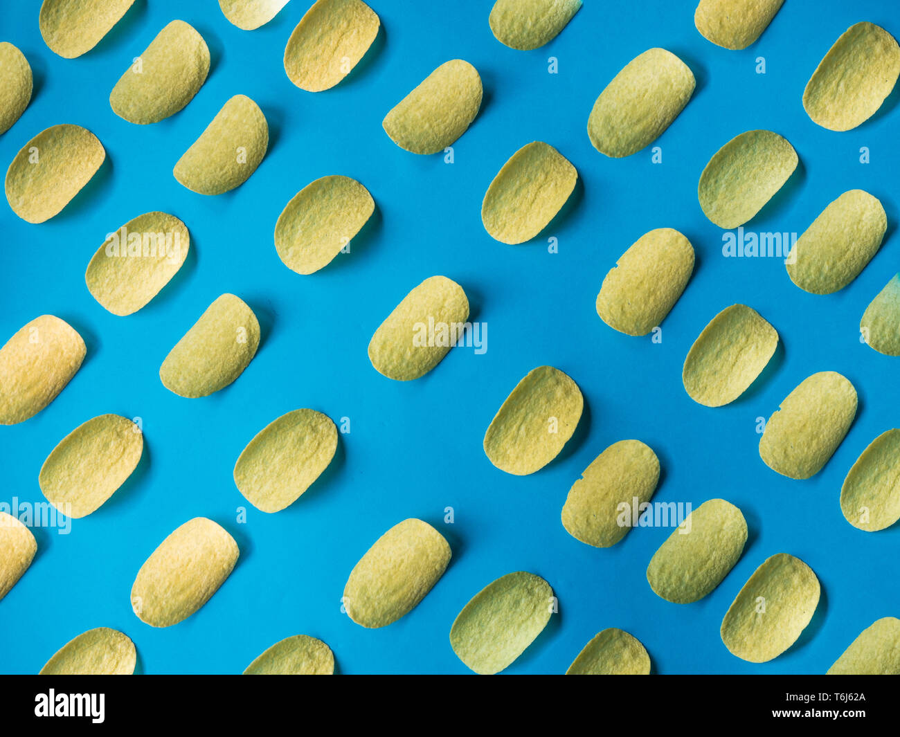 Potato chips pattern on blue background Stock Photo - Alamy